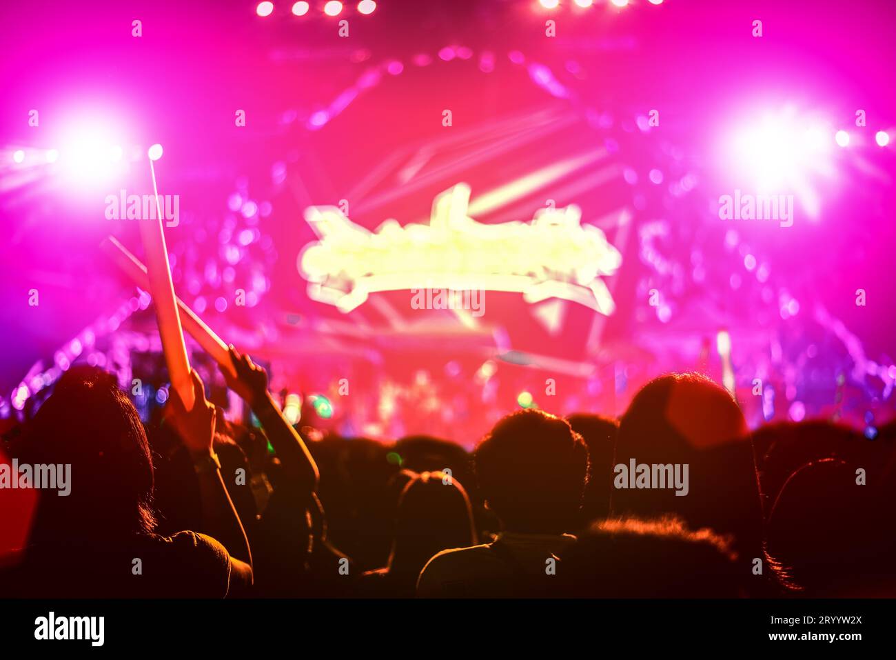 Rock concert with silhouettes people in happy gesture and raising up ...