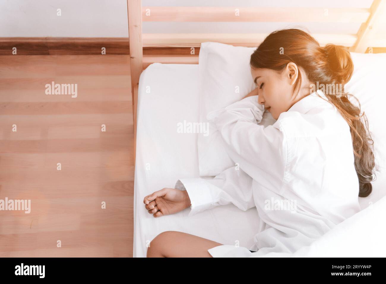 Young Asian woman sleeping on white bed in the morning. Beauty and ...