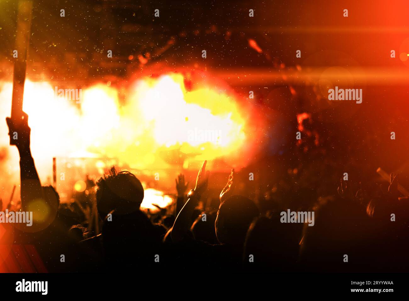 Rock concert with silhouettes people in happy gesture and raising up ...