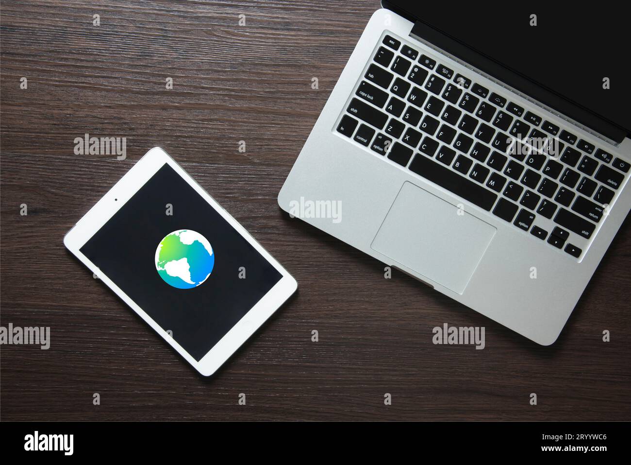 Internet communication globe in the device screen Stock Photo - Alamy