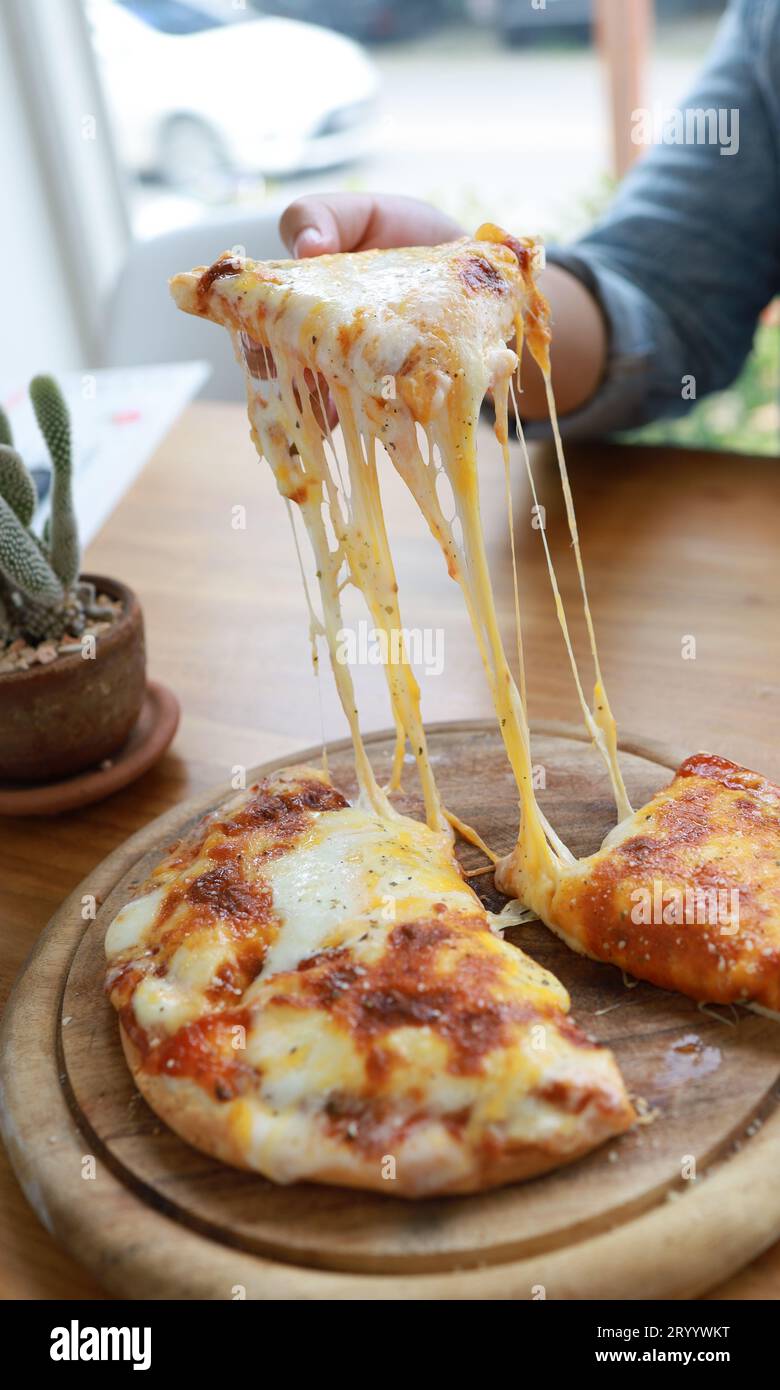 A slice of fresh hot Very cheesy vegetarian pizza mozzarella cheese ...