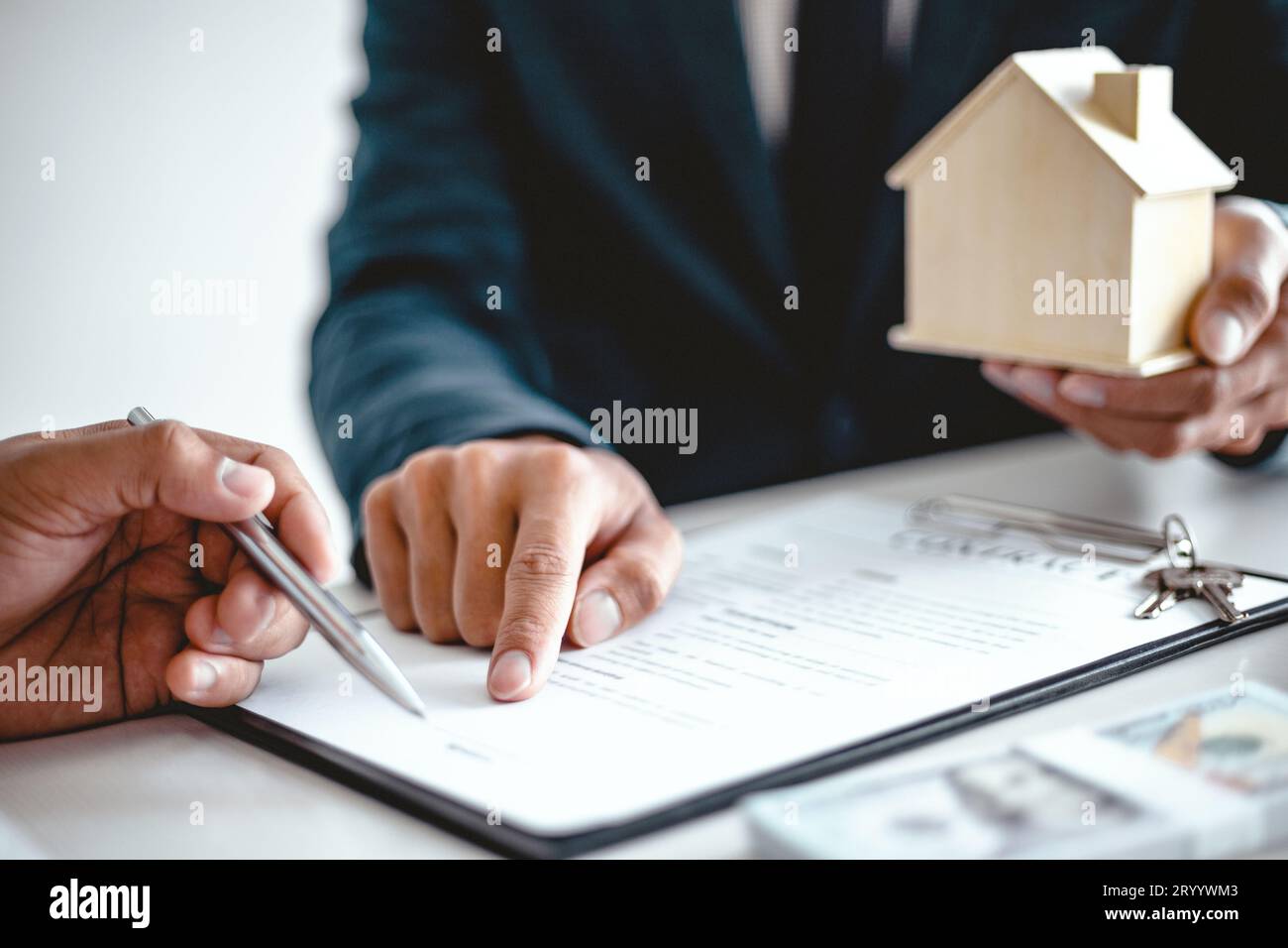 Business people signing contract making a deal with real estate agent ...