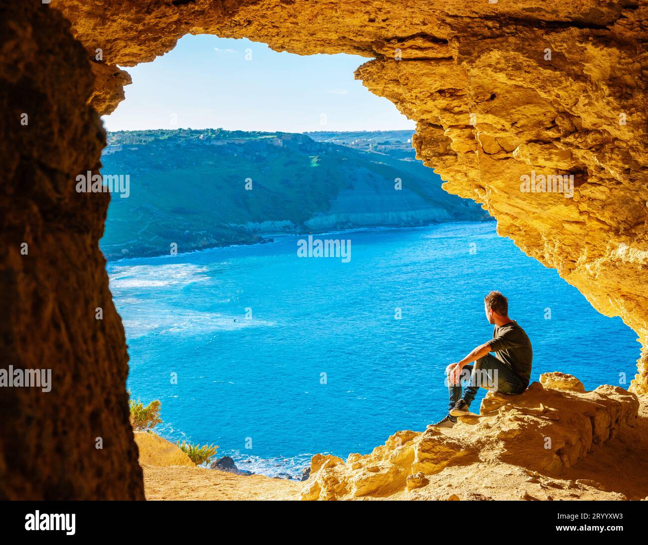 Gozo island Malta, young man and a View of Ramla Bay, from inside Tal ...
