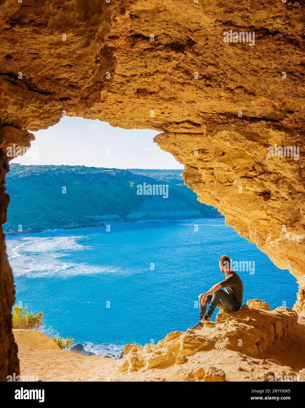 Gozo island Malta, young man and a View of Ramla Bay, from inside Tal ...