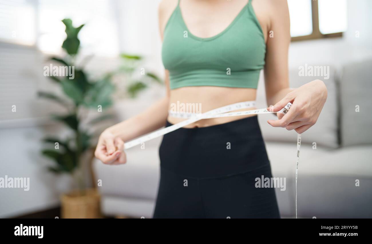 Asian healthy woman dieting Weight loss. Slim woman measuring waist ...