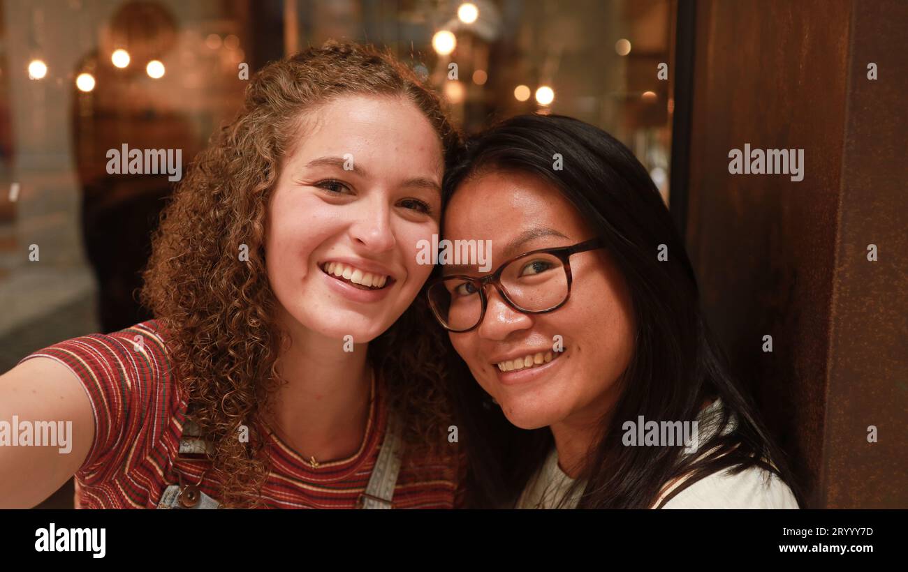 Girlfriends. Pretty multiracial female friends taking selfie with smartphone Lifestyle selfie ...