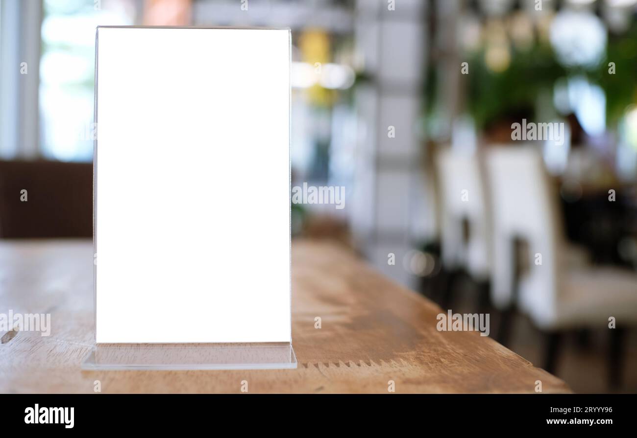 Menu frame standing on wood table in Bar restaurant cafe. space for ...