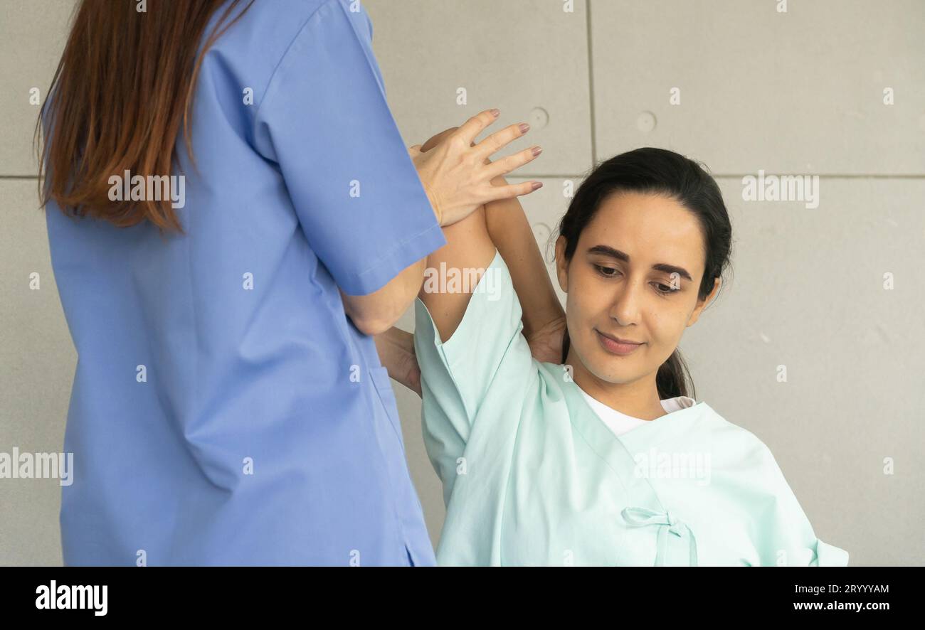 Female Caucasian physiotherapist rehabilitation with Hispanic patient ...