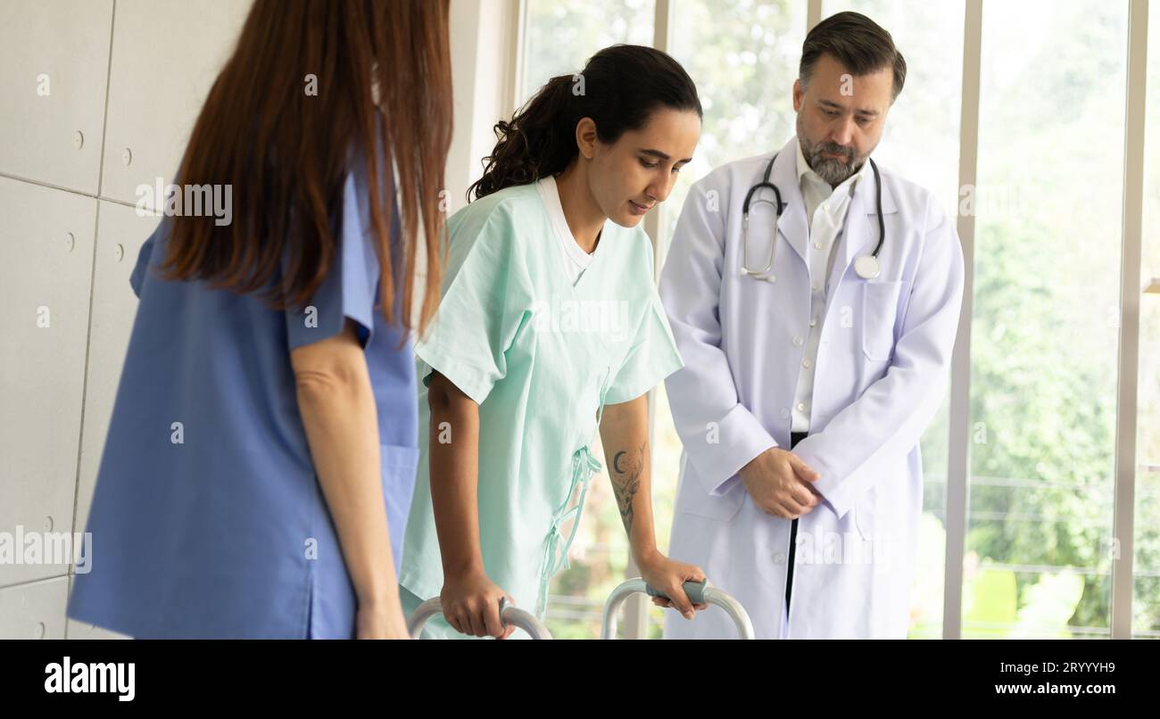 Doctor and physiotherapist doing a rehabilitation recovery for Hispanic ...