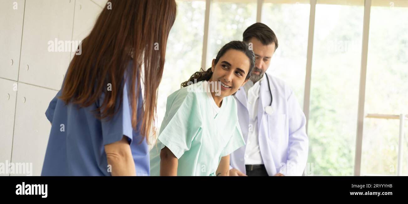 Doctor and physiotherapist doing a rehabilitation recovery for Hispanic ...