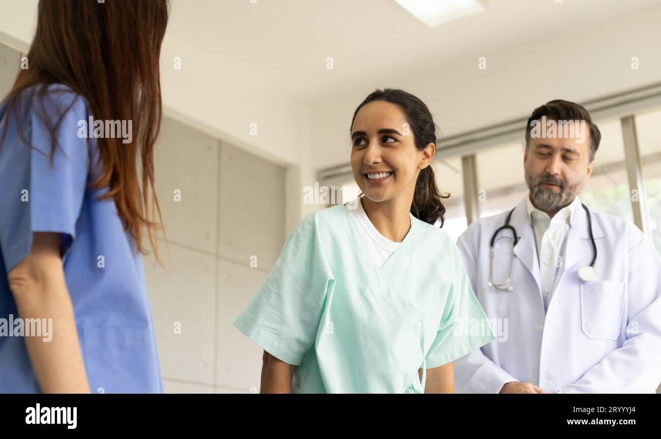 Doctor and physiotherapist doing a rehabilitation recovery for Hispanic ...