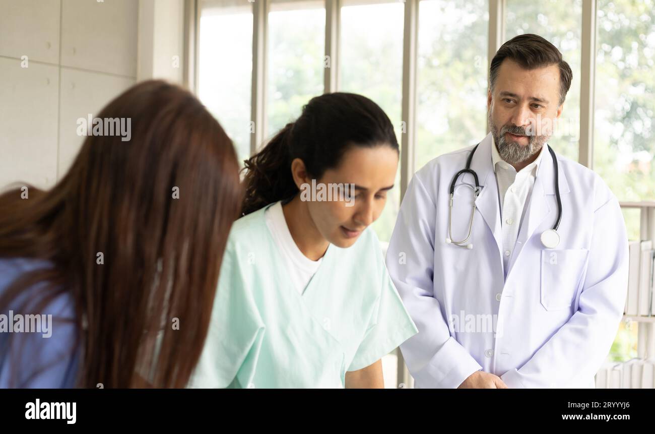 Doctor and physiotherapist doing a rehabilitation recovery for Hispanic ...