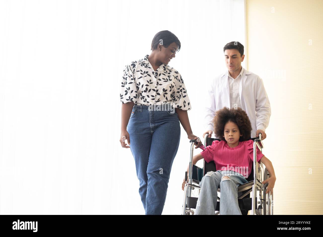 Doctor doing a rehabilitation recovery for mixed-race patient girl ...