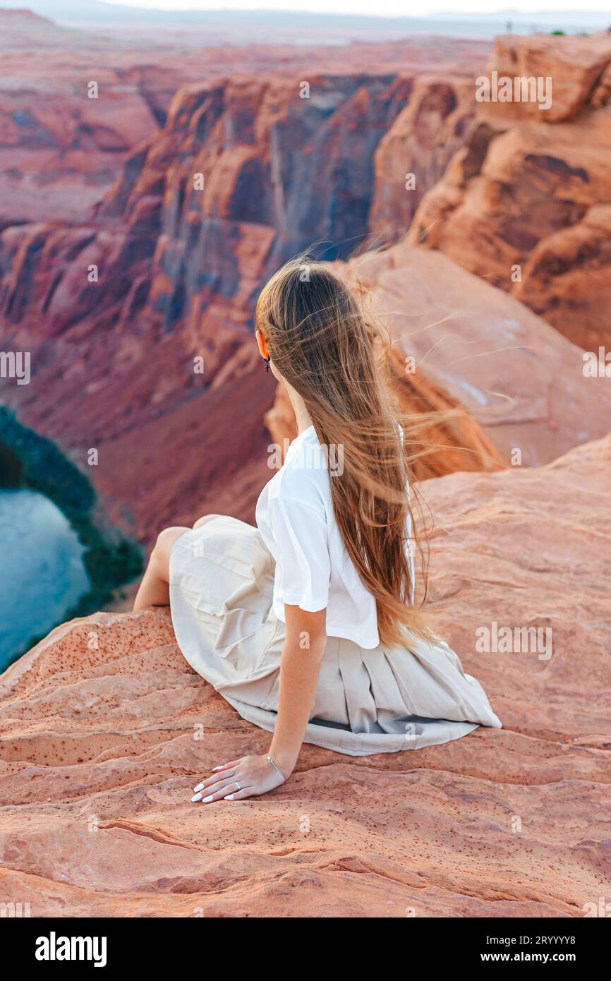 Happy girl on the edge of the cliff at Horseshoe Band Canyon in Page ...