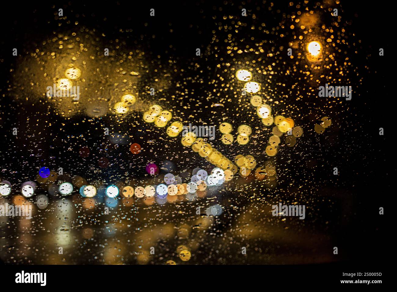 beautiful melted background on the front fogged car window in the rain ...