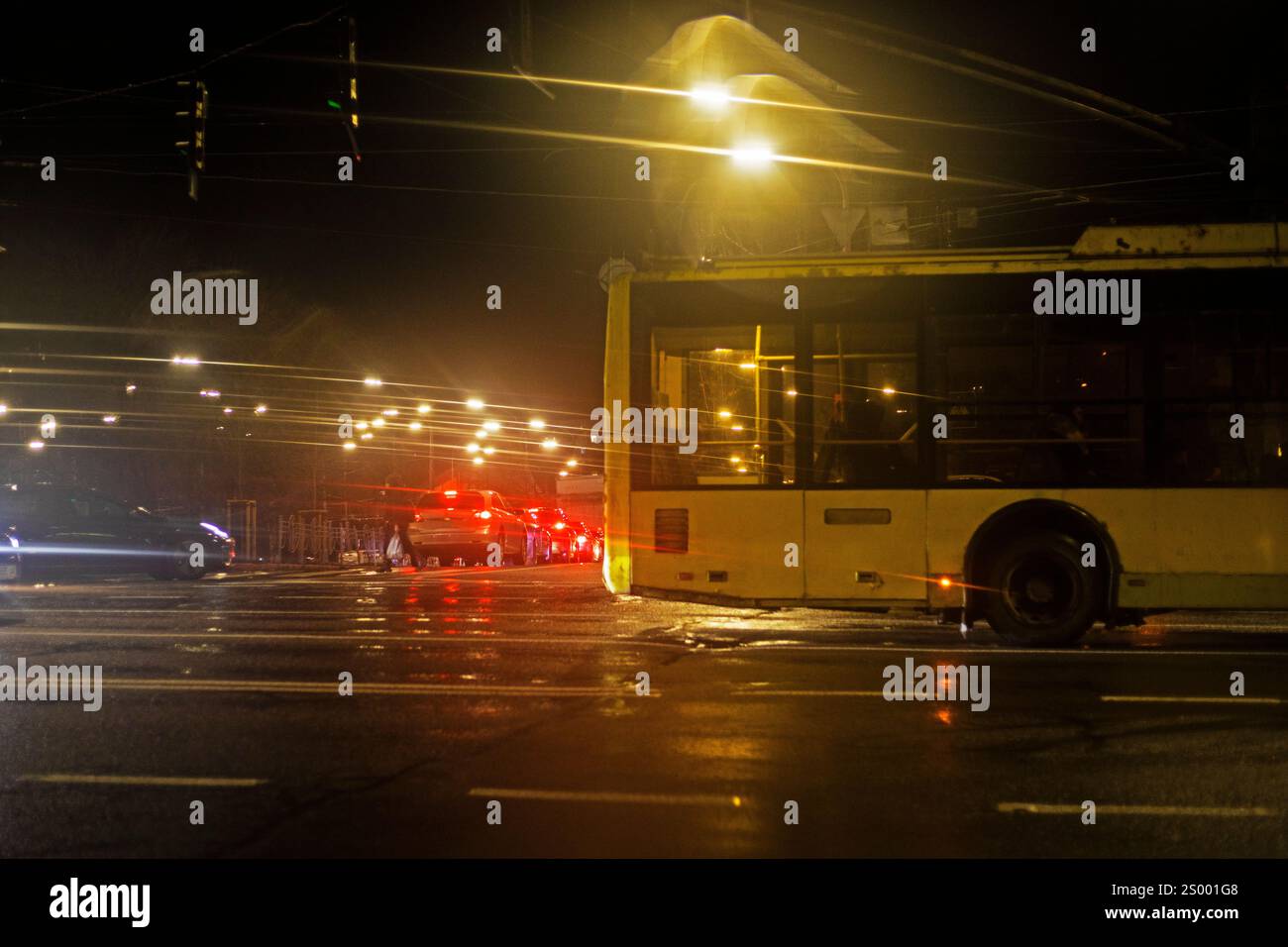 traffic jam at the intersection with a broken trolleybus late at night ...