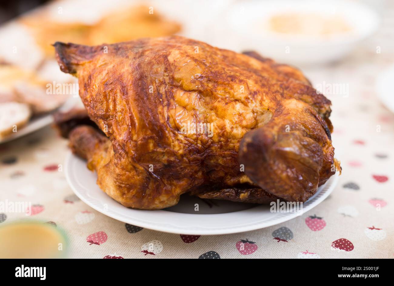 Whole roasted chicken on a plate Stock Photo - Alamy