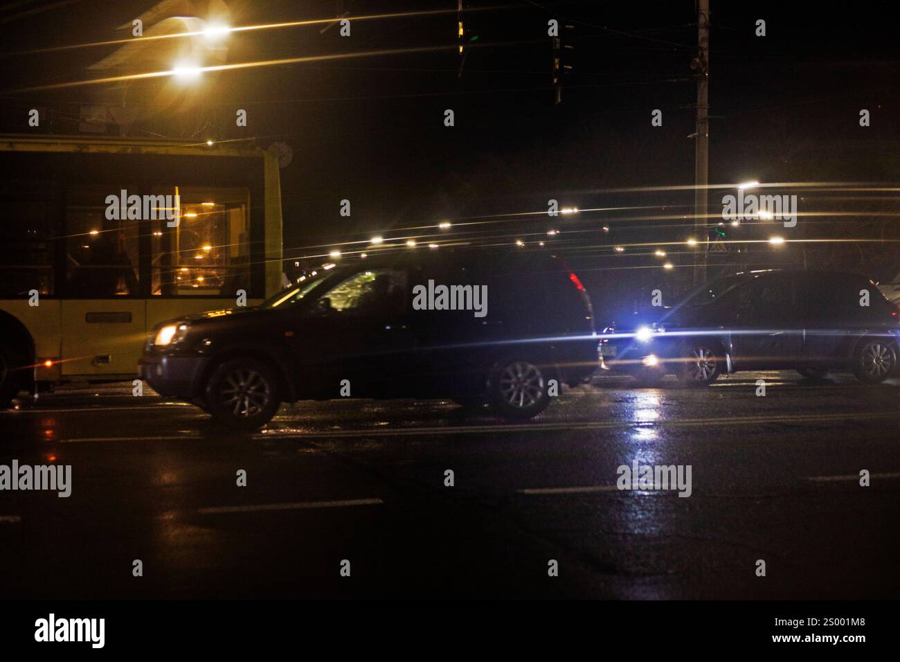 traffic jam at the intersection with a broken trolleybus late at night ...