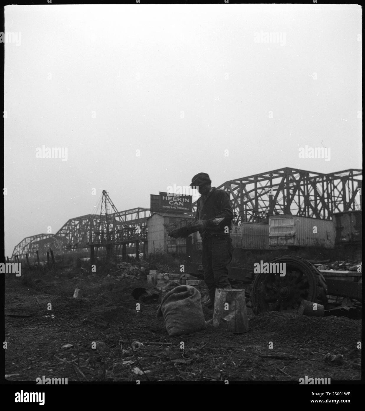 Cincinnati, Ohio, USA. circa 1937. People; man searching through ...