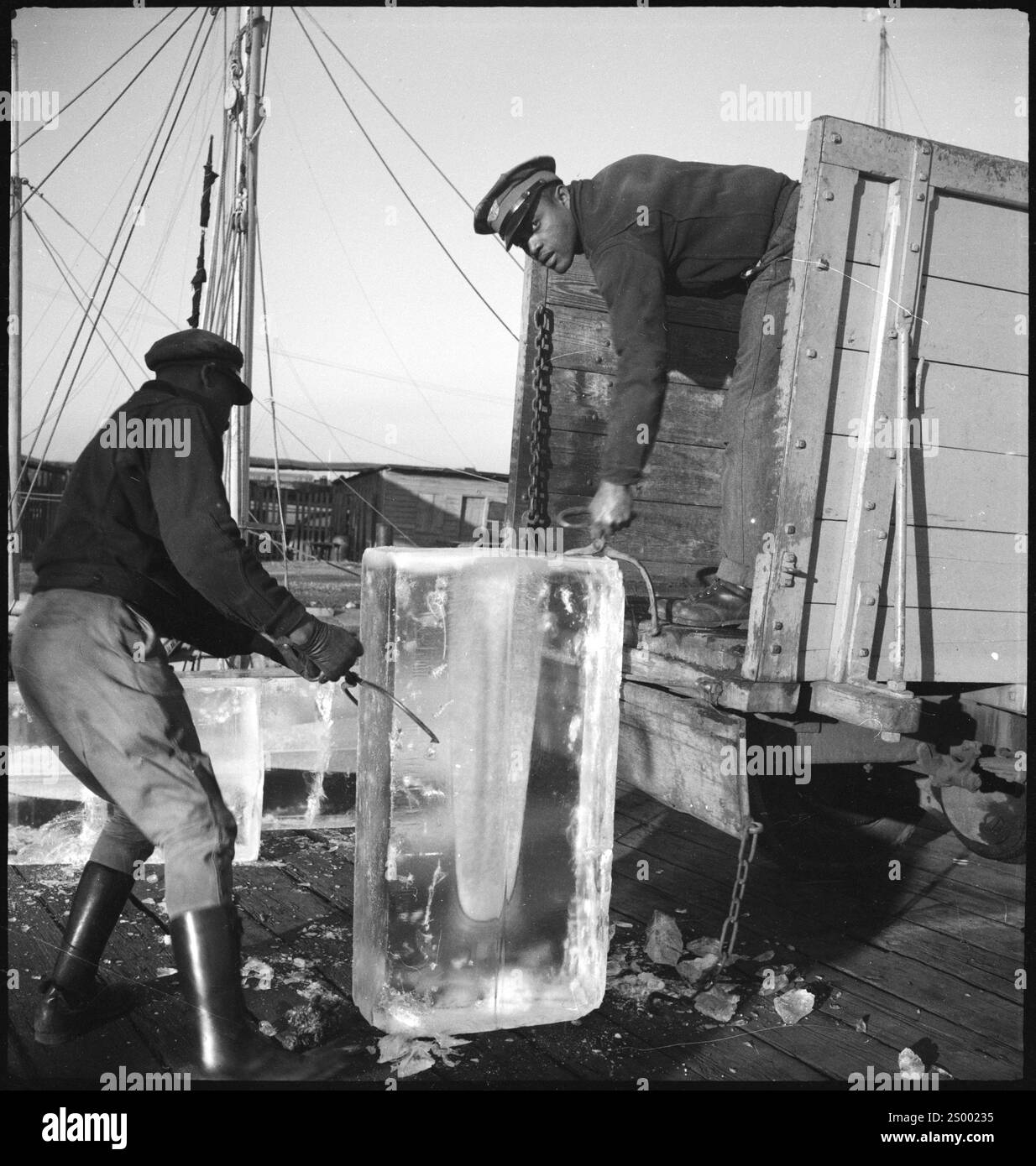 Charleston, South Carolina, USA. Harbor; Two men loading ice blocks ...