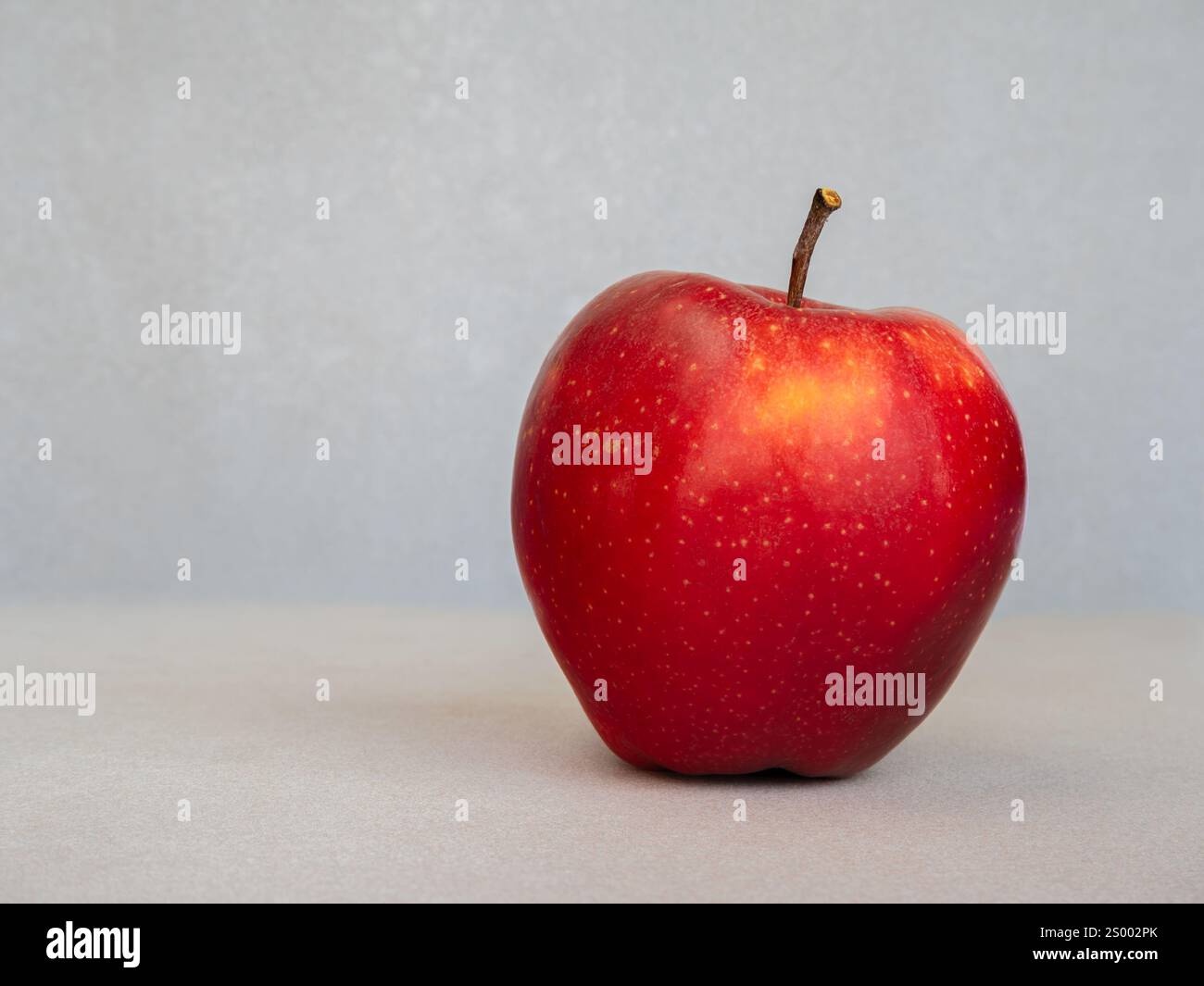 One red apple on a ceramic tabletop Stock Photo - Alamy
