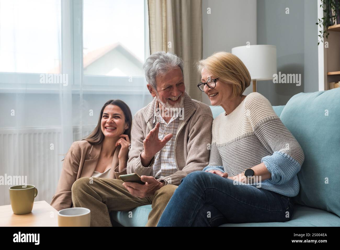 Simple living. Granddaughter visiting grandmother and grandfather at ...