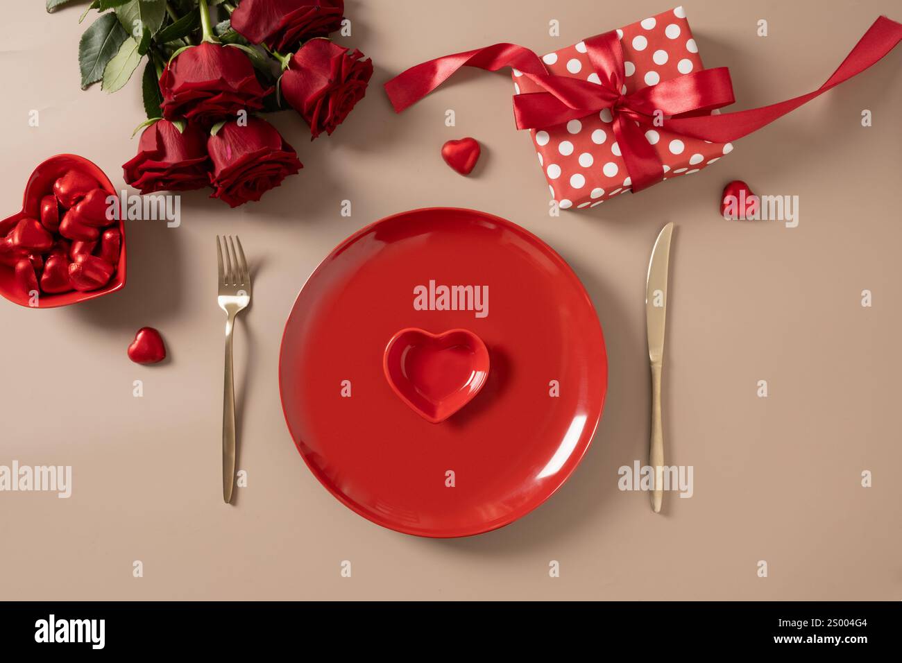 Valentine's day. Romantic dinner for date with red plate, chocolate sweets, romantic gift and ...