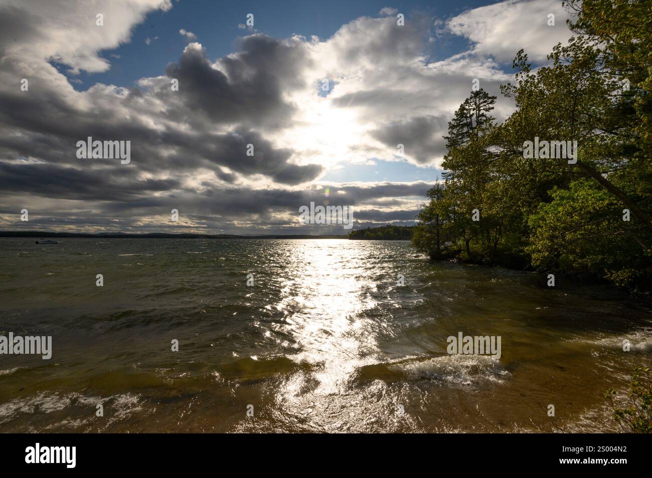 A mix of sun and clouds in the skies over Lake Winnipesaukee, the ...