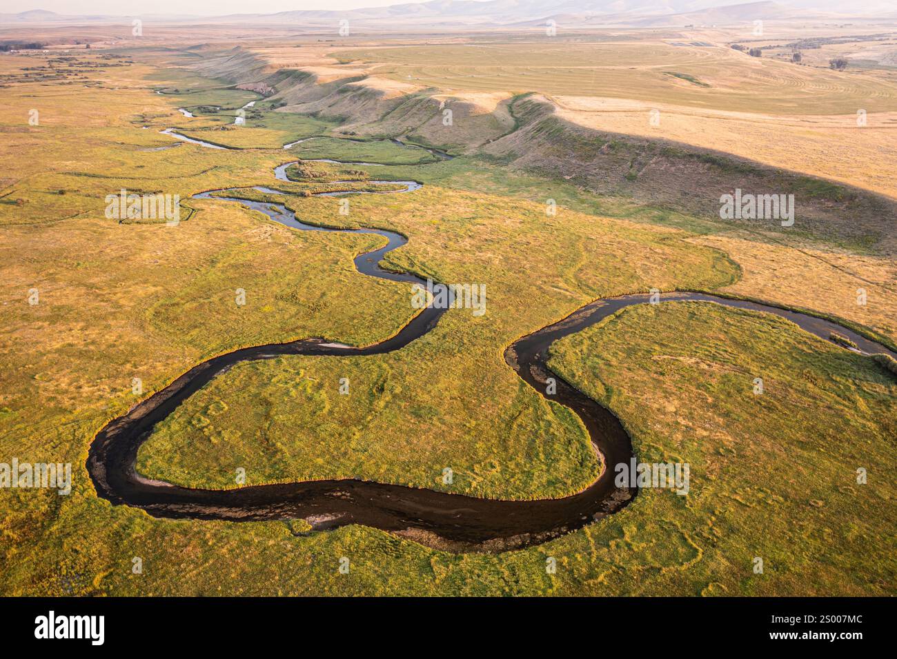 River winding through open field during late summer in Montana Stock ...