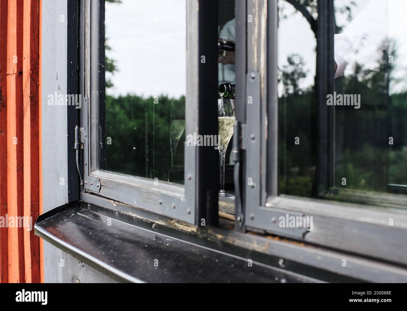 view of champagne being poured through a window celebrating Stock Photo ...