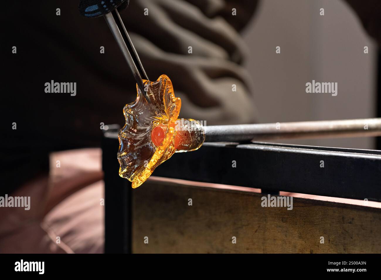 Molding molten glass into a flower shape, works of glass blowing workshop Stock Photo - Alamy