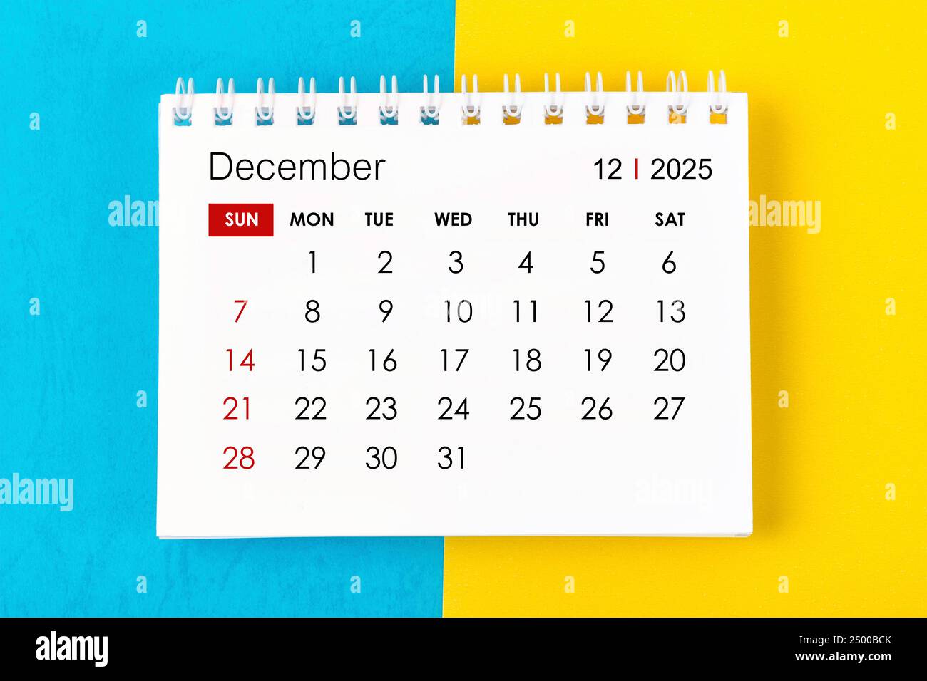 December 2025 Monthly desk calendar for 2025 year on blue and yellow ...