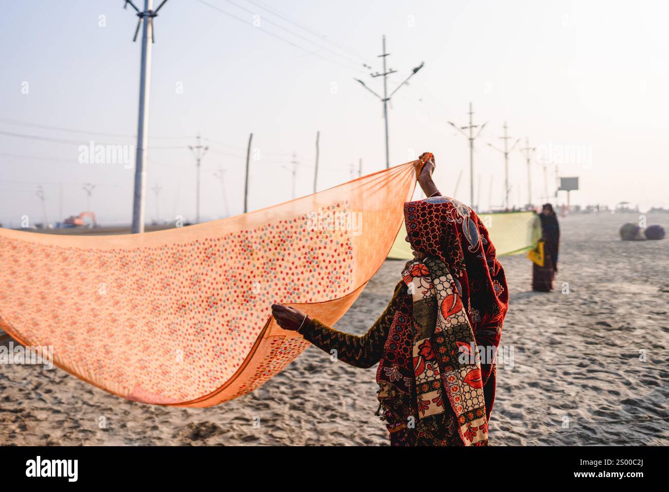 Hindu devotees dry a sari after taking a holy dip at Sangam, ahead of ...