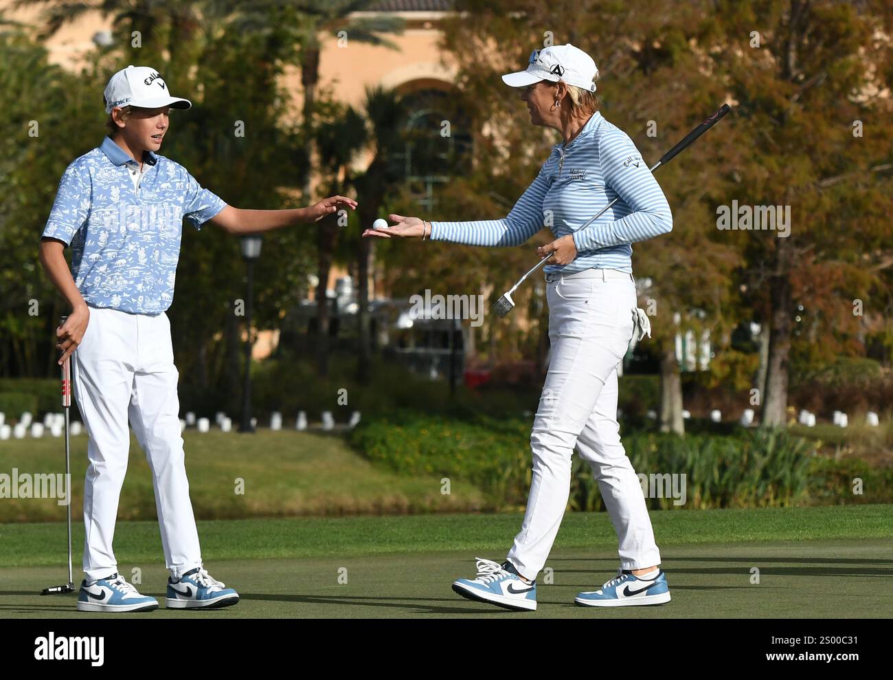 Annika Sorenstam hands a ball to her son, Will McGee, on the 18th green ...