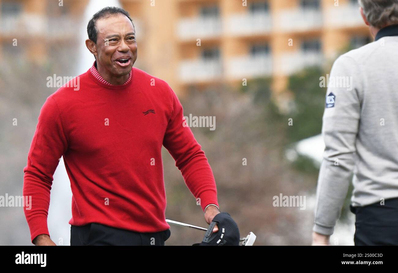 Tiger Woods congratulates Bernhard Langer (face not shown) on the 18th ...