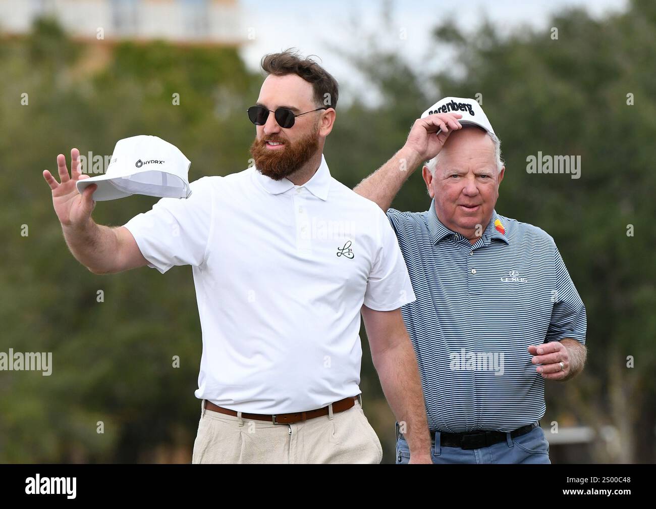 Mark O’Meara (R) and his son, Shaun O’Meara, wave to the crowd on the ...