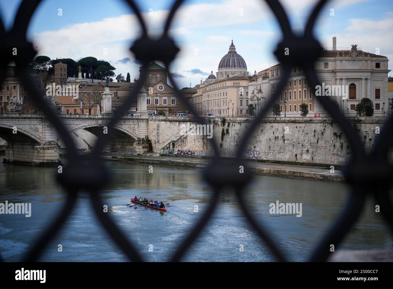 A canoe sails along the Tiber river past St.Peter's Basilica, in Rome ...