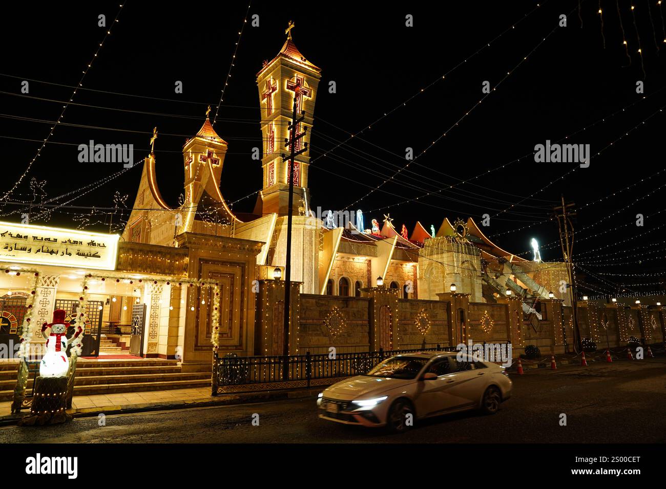 A car drives past the Mar Behnam and Sarah Church in the town of ...