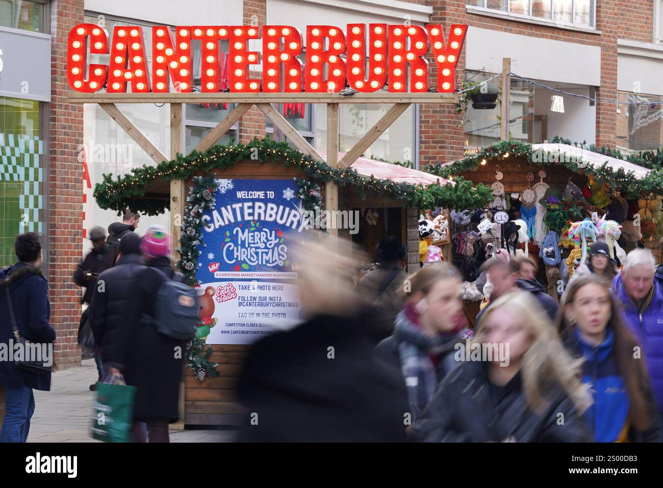 Shoppers walk through a Christmas Market in Canterbury, Kent, ahead of ...