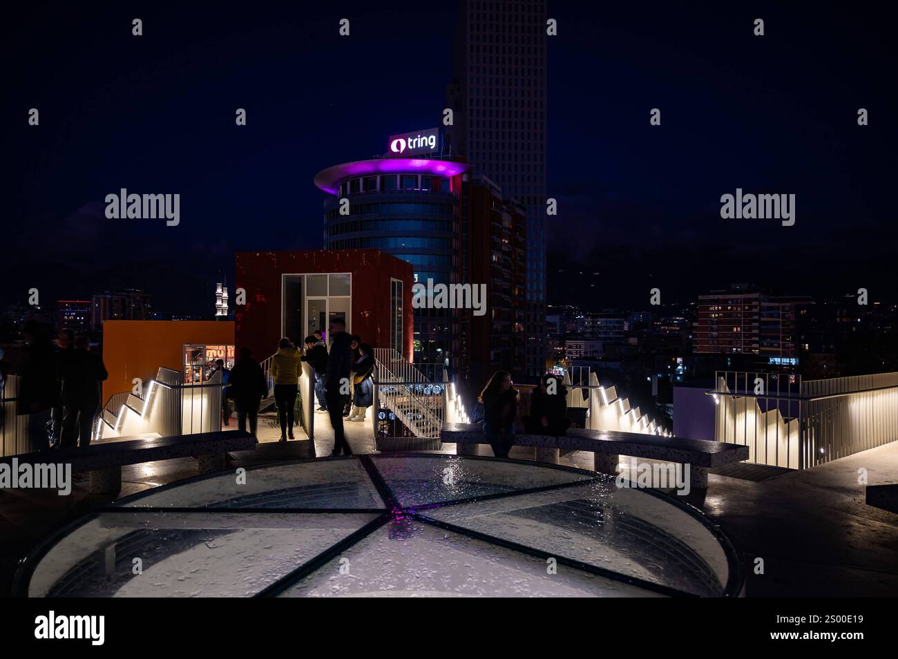 Tourists at the panoramic platform at the Pyramid ofTirana by night ...
