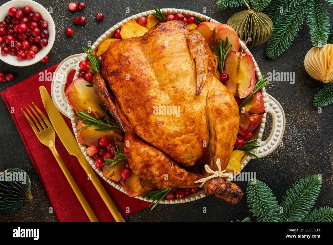 Christmas roasted chicken with apples, potatoes, cranberries, sauce and ...