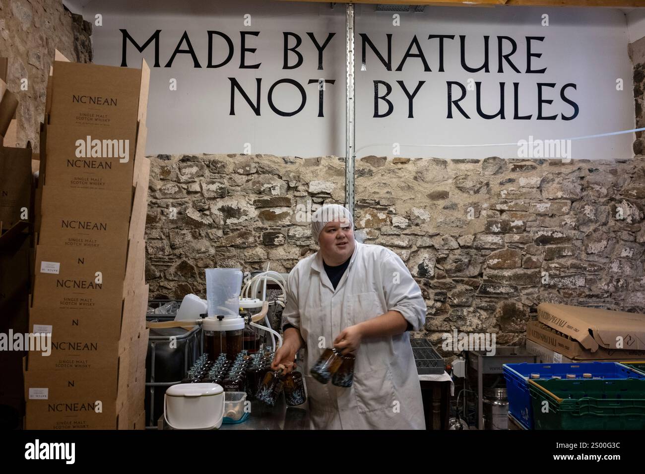 Torran Mealand bottling the whisky spirit into the bottles which are ...