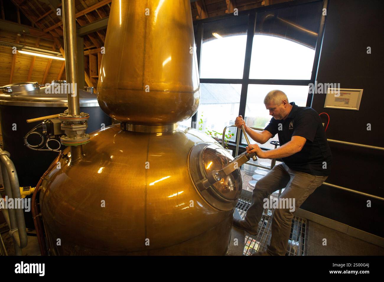 Gordon Wood, distillery manager, prepares the stills at the beginning ...