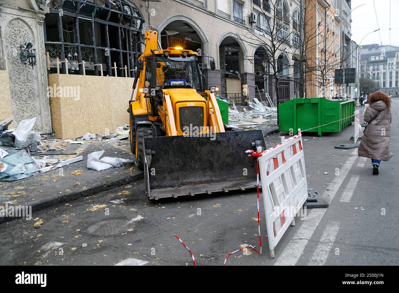KYIV, UKRAINE - DECEMBER 23, 2024 - A bucket loader is used to clean ...