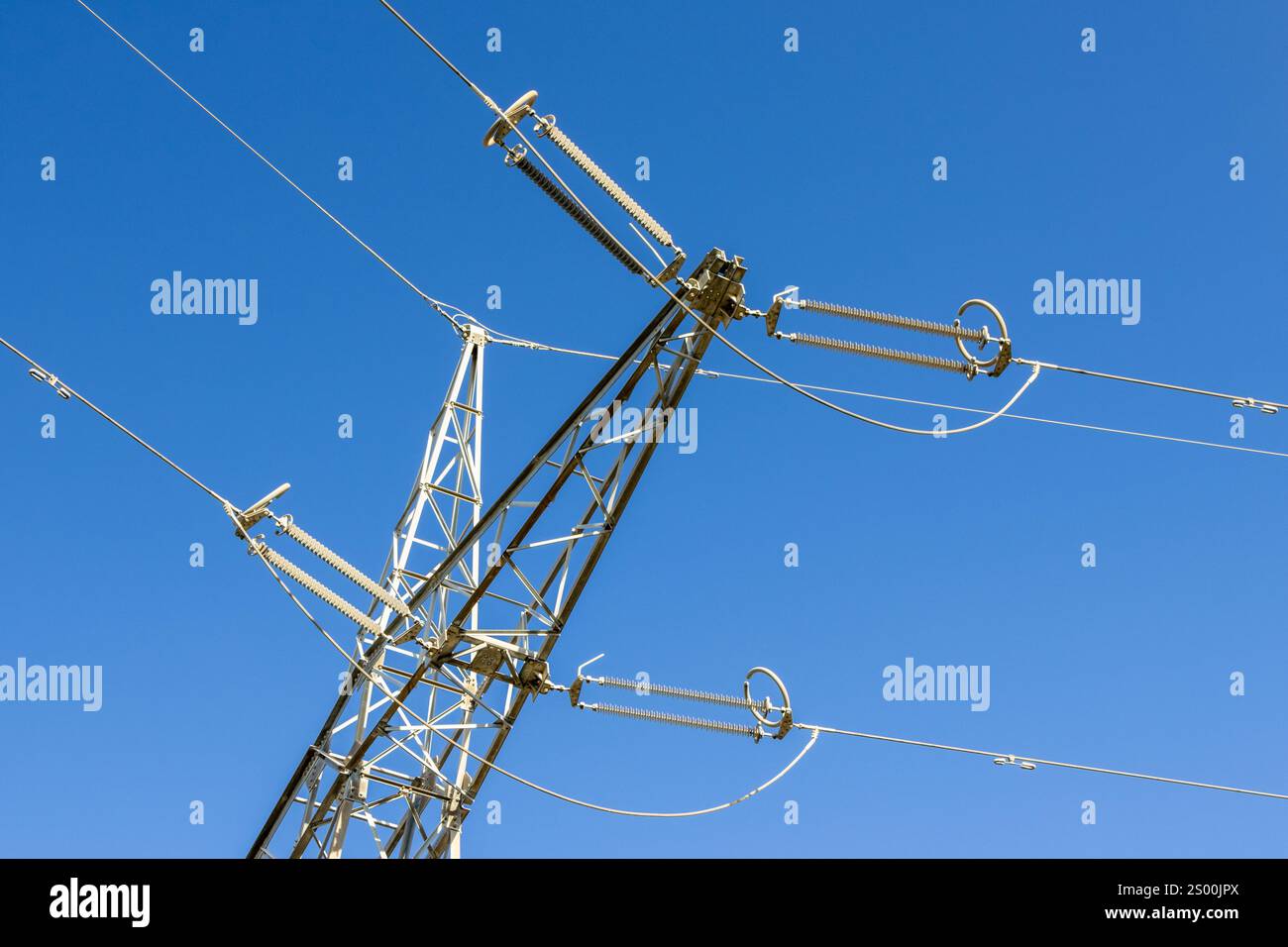 Metal electric pylon carrying high voltage power lines under a clear ...