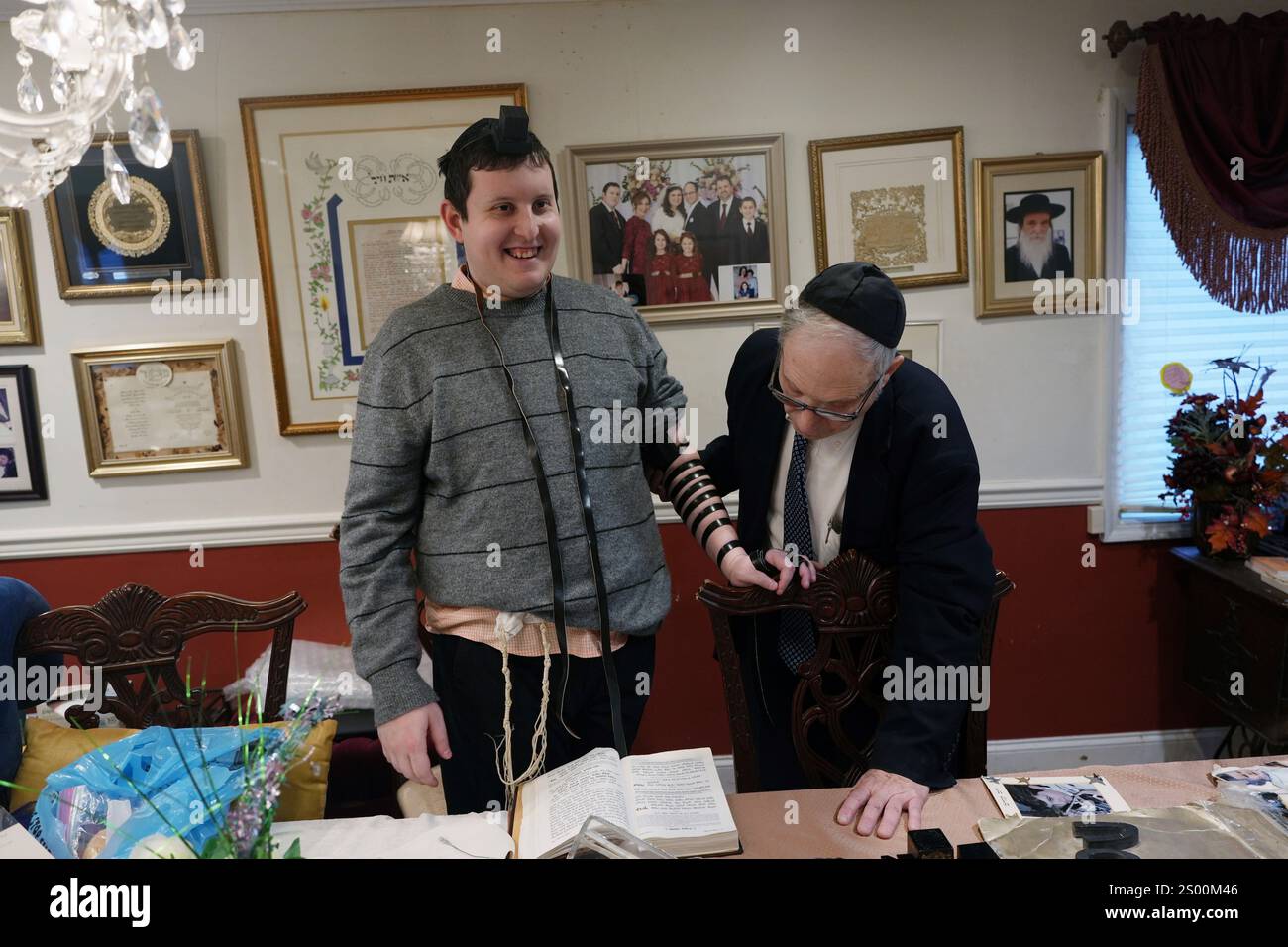 Dov Marcus smiles after wrapping the leather straps of tefillin to pray ...