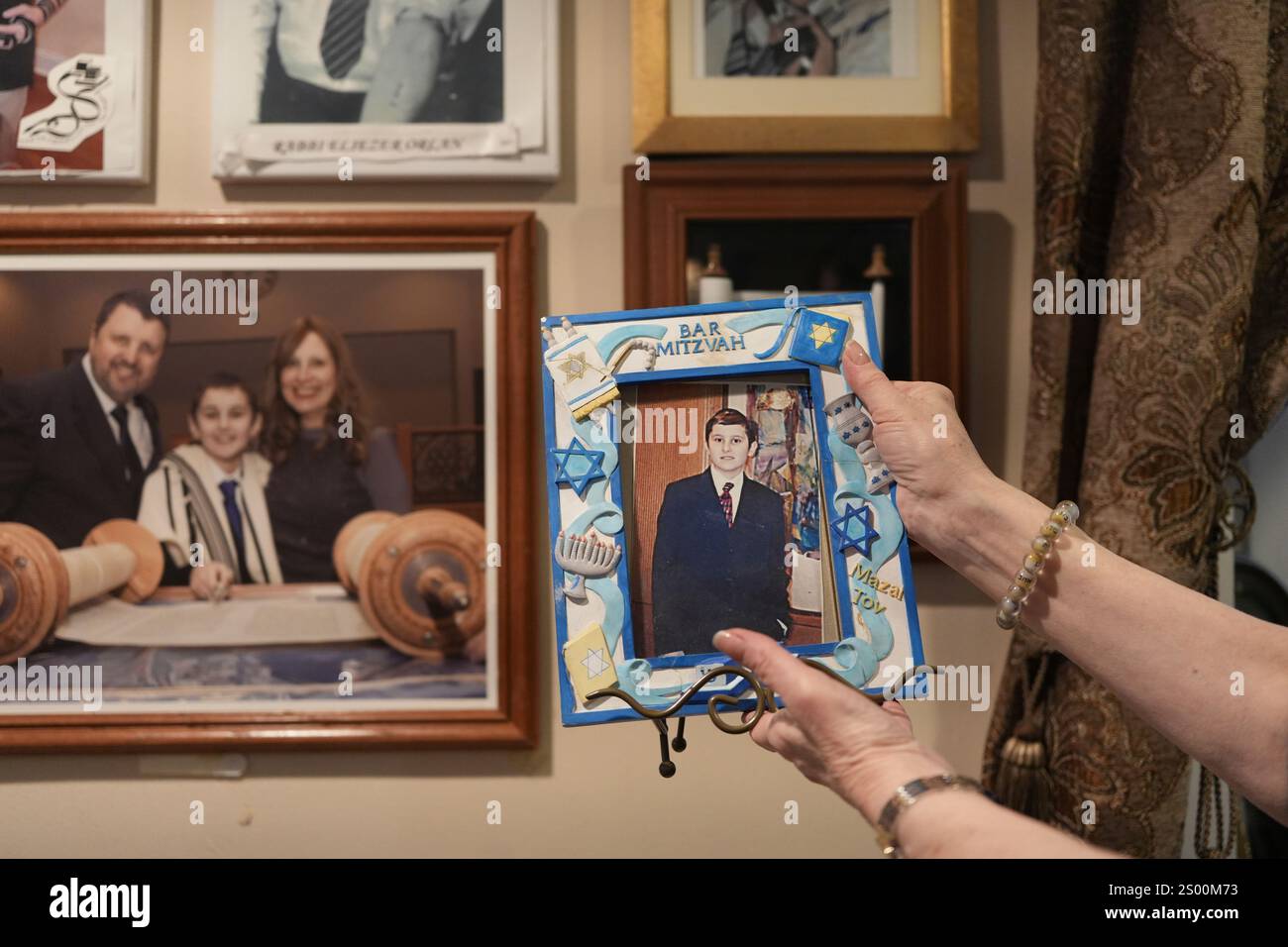 Debbie Marcus shows a framed photo of her son, Dov Marcus, taken at his ...