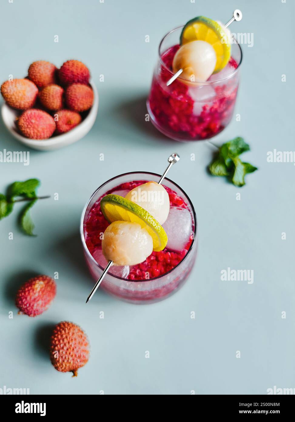 Refreshing lychee drink with raspberry, lime, mint leaves and ice. Non-alcoholic sparkling ...