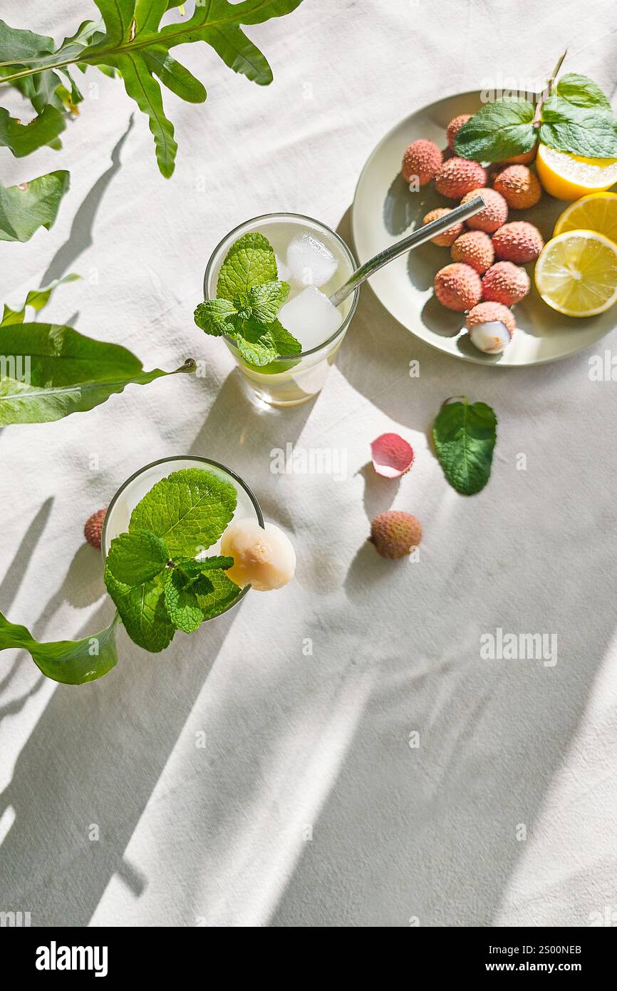 Refreshing lychee drink with lime, mint leaves and ice. Non-alcoholic sparkling cocktail fizzy ...