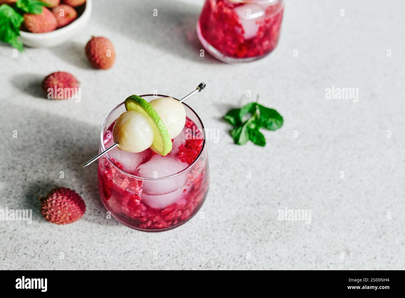 Refreshing lychee drink with raspberry, lime, mint leaves and ice. Non-alcoholic sparkling ...